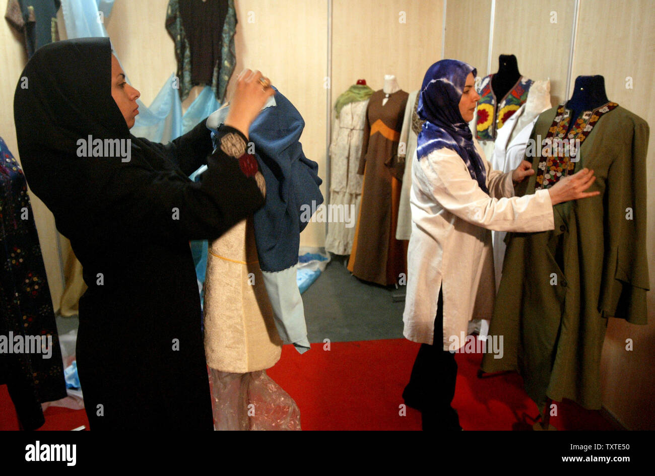Iranian designers Fatima Ghaffari (L) and Somayyeh Nik Mohammadi dress ...