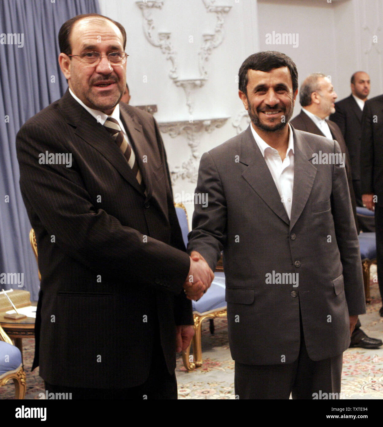 Iranian President Mahmoud Ahmadinejad (R) shakes hand with Iraqi Prime ...