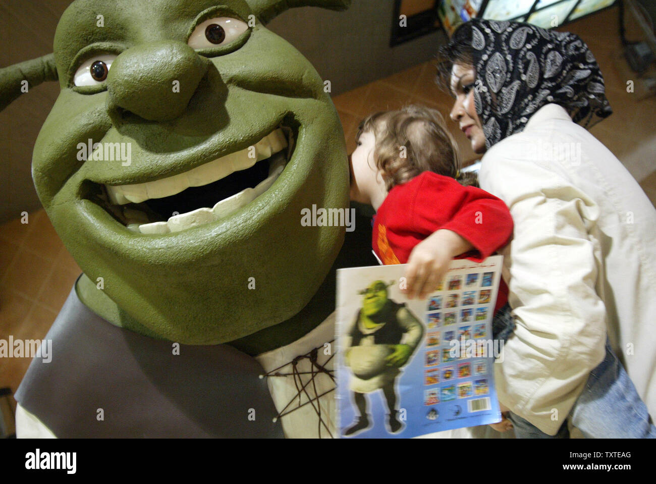 An Iranian woman holds her two-year-old daughter Kianaz Keyvani as she ...