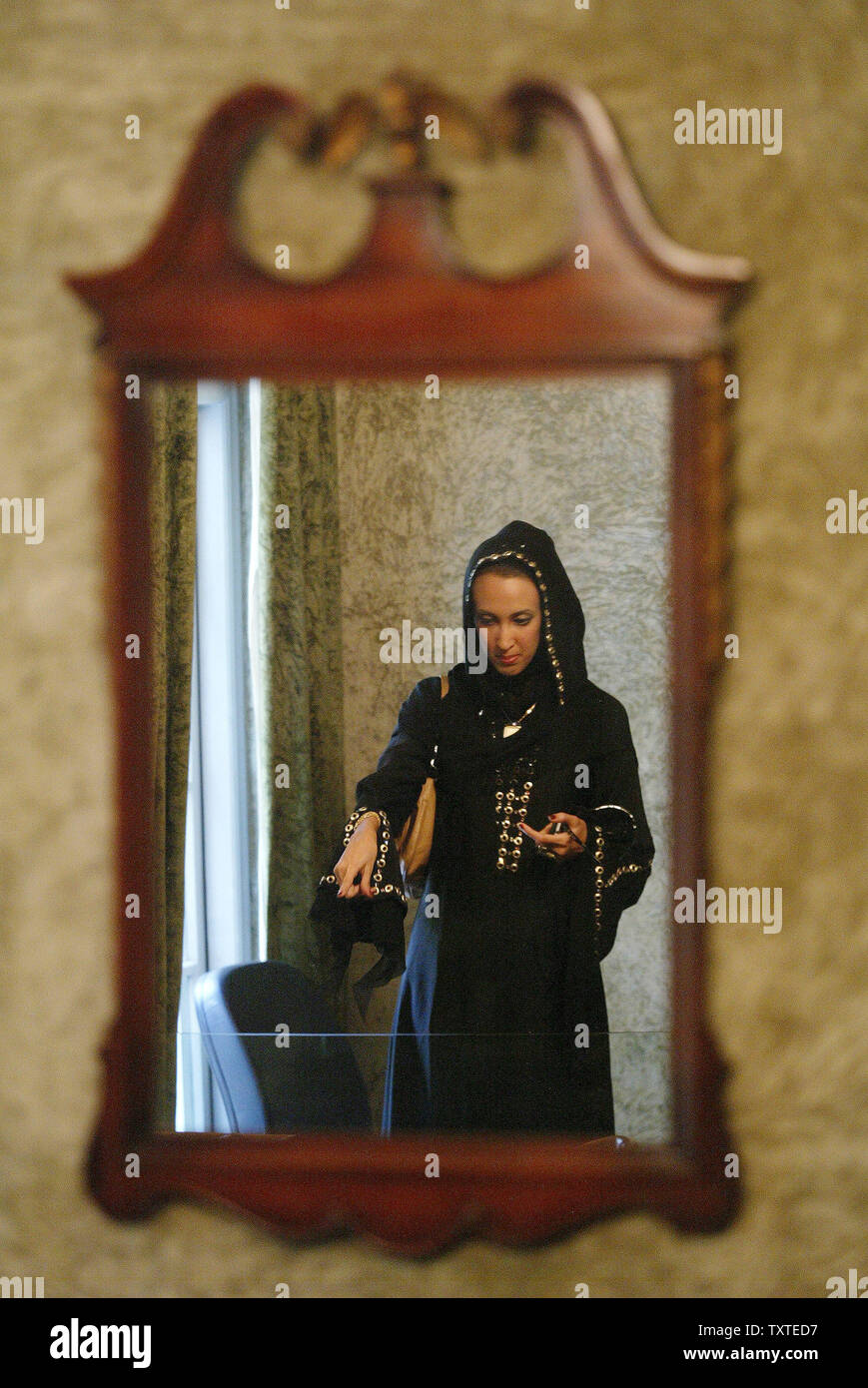 Saudi Arabian princess Nauf Bent Al-Bandar is seen in a mirror as she ...