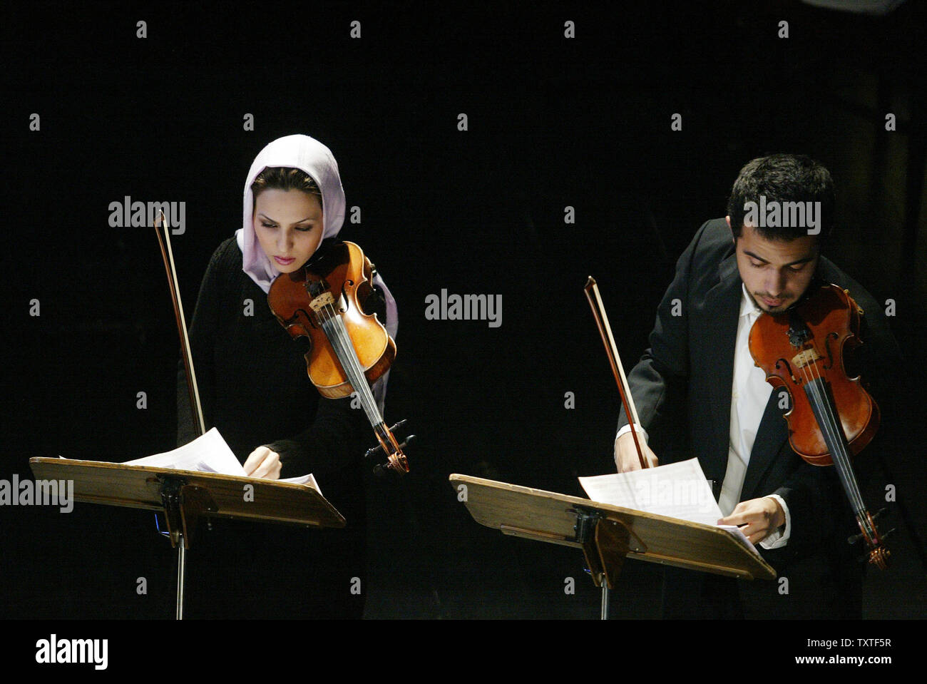 Iranian violinists change their notes while they perform at the 23rd ...