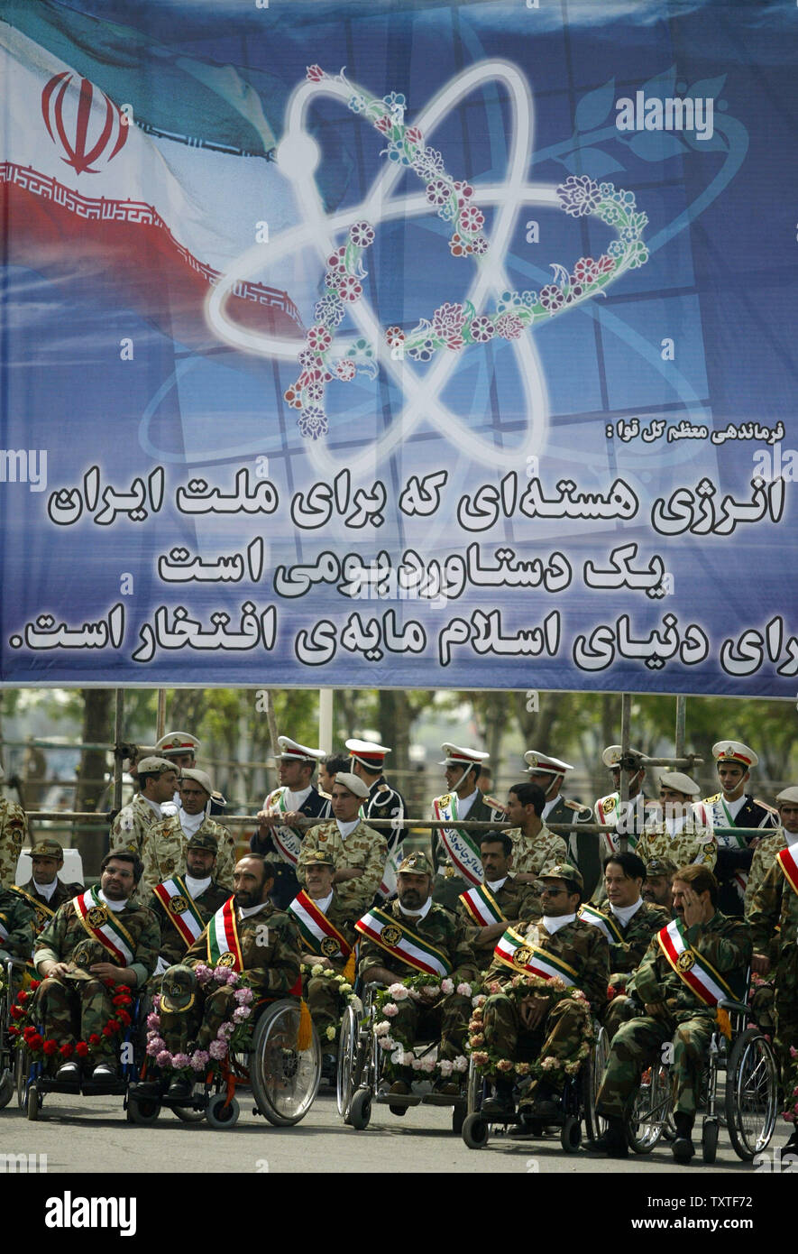 Iranian war veterans are seen under a nuclear banner during Iran's Army ...