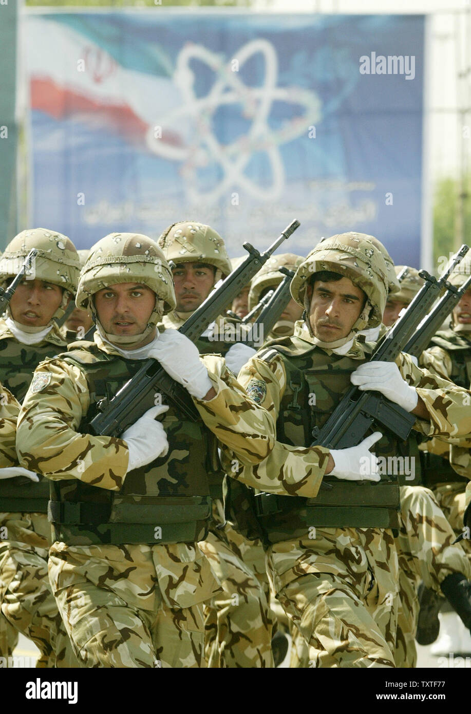 Iranian Army soldiers march under a nuclear sign during Iran's Army Day ...
