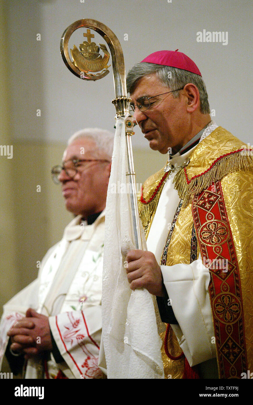 Iranian Assyrian Christian bishop, Ramzi (R), prays on the first day of ...