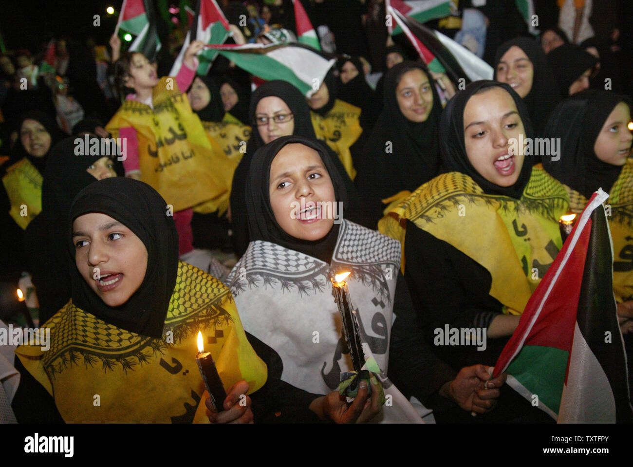 Iranian girls hold Palestine flags while they chant slogan during an ...