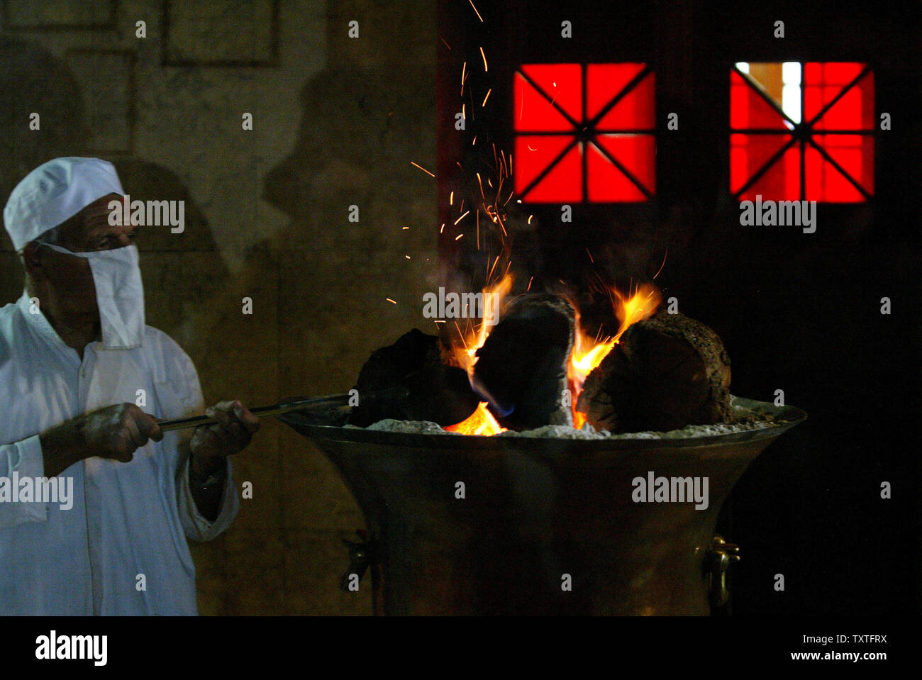 Farrokh Jamshidi, Iranian Zoroastrian priest, adjusts the wood of a ...