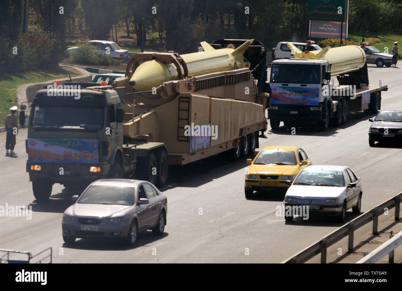 Military trucks transport an Iranian Shahab 3 army missile (L) and a ...