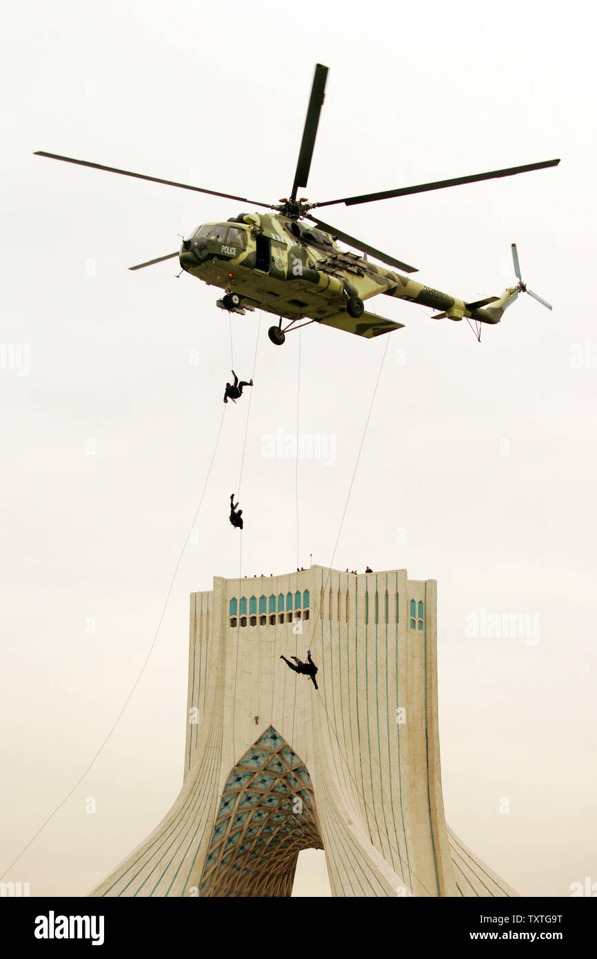 An Iranian military helicopter discharges anti-riot police during a ...