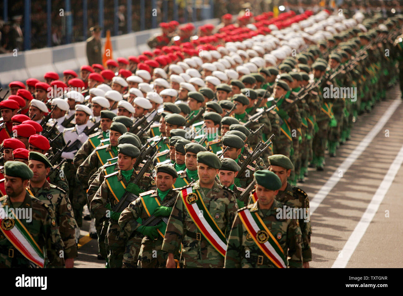 Iranian Army soldiers march while they wear clothes shows Iran's flag ...