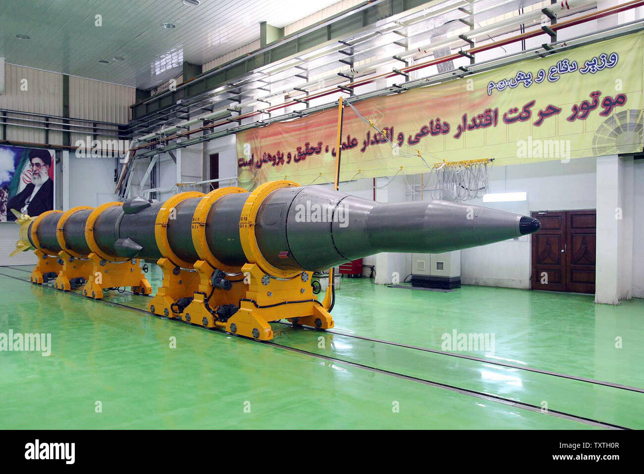 Iran's missile Sejil 2 is seen before its launch by Iranian armed forces in front of a picture ...
