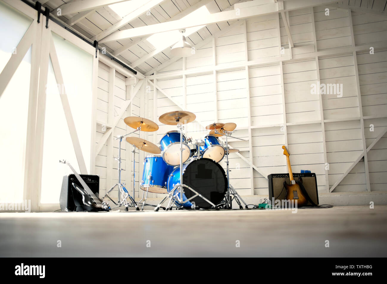 Musical instruments and equipment inside a white garage Stock Photo - Alamy