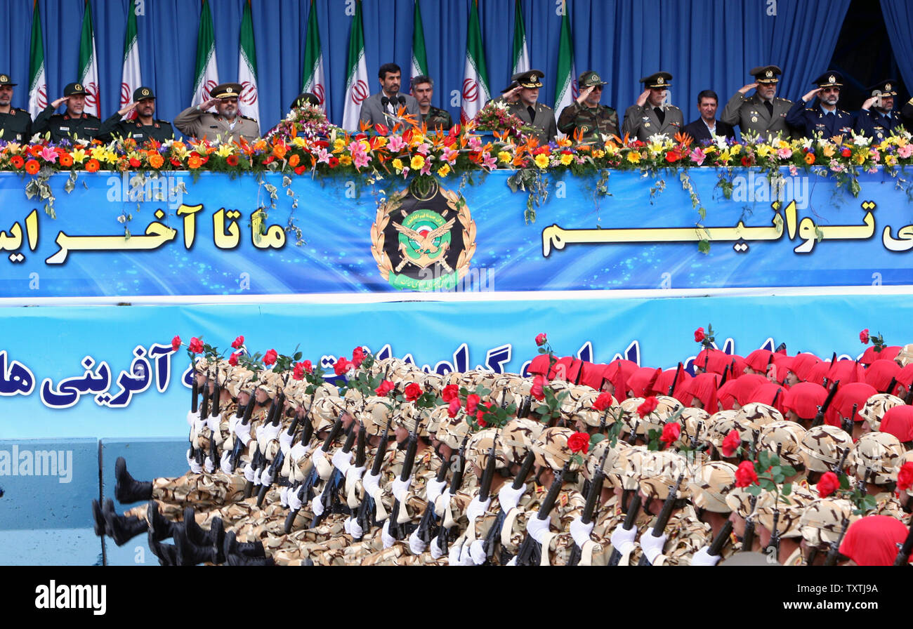 Iranian soldiers march past Iranian President Mahmoud Ahmadinejad ...