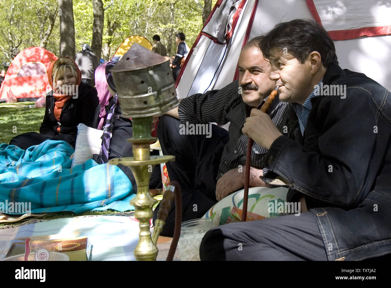 Iranian men smoke Shisha in a park to mark the 13th day of Norouz, in ...