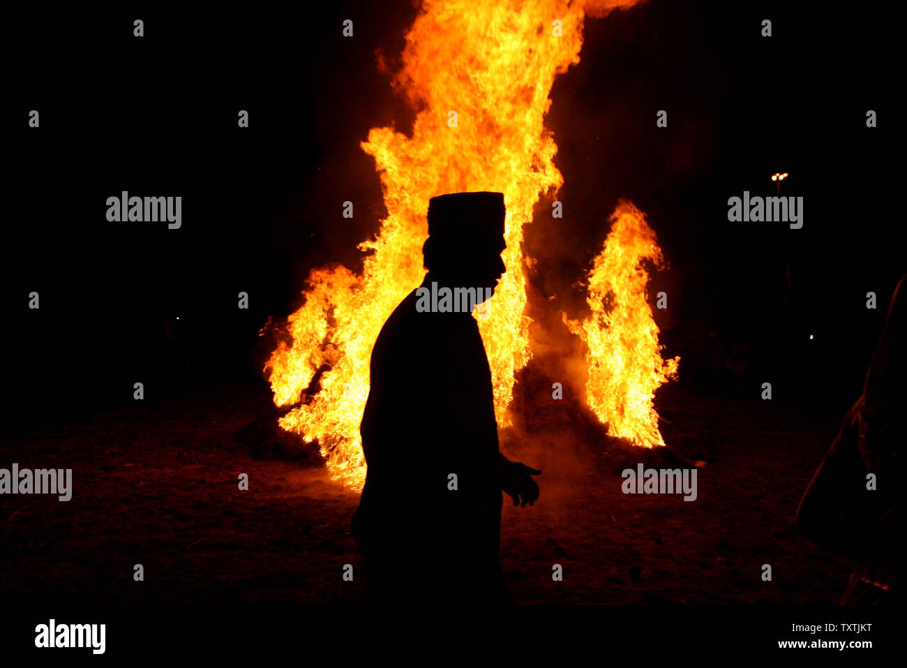 Iranian Zoroastrian Mobed (Priest) walks around a fire during a ...