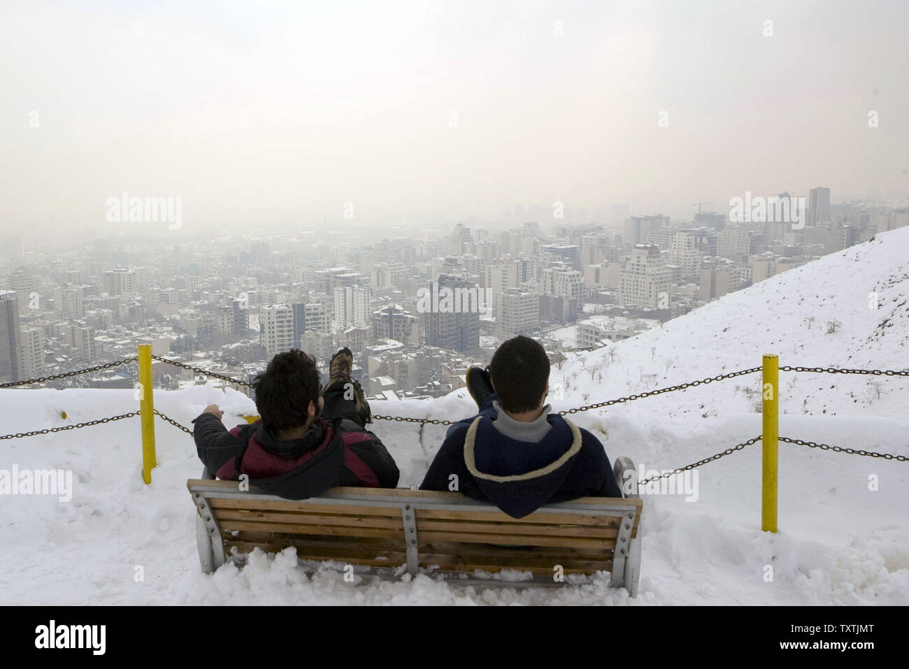Iranian boys look over the snowy city of Tehran, Iran on January 17 ...