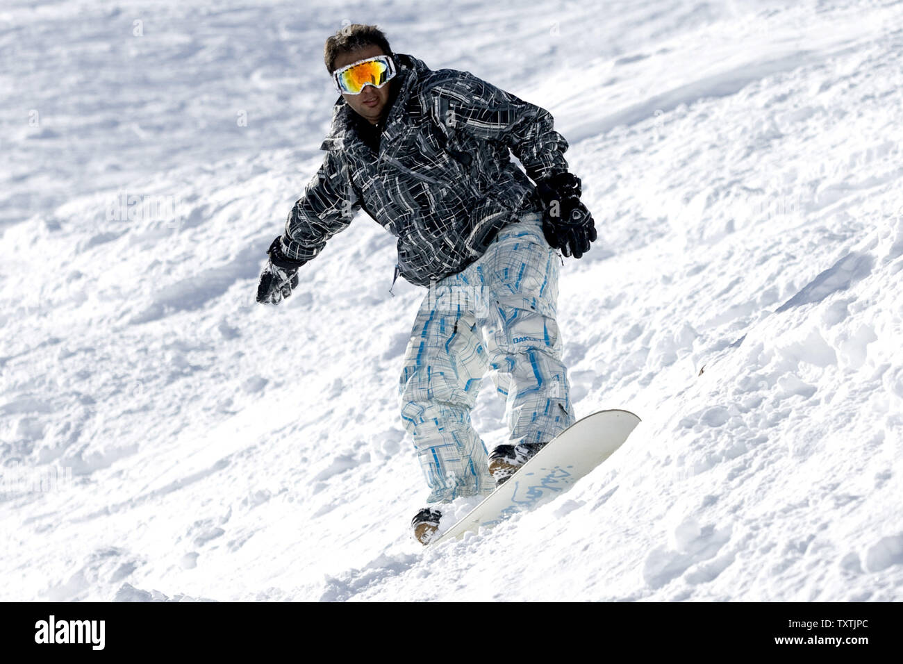 An Iranian man snowboards at the Shemshak ski resort, in the Alborz ...