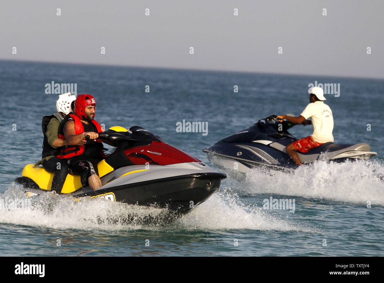 Men ride jet skis in the Persian Gulf off Kish Island in southern Iran ...