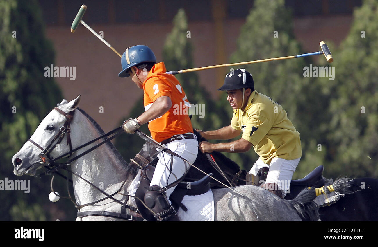 Iranian polo players Amir khoe (L) and Ahmad Fatahi compete for the ...