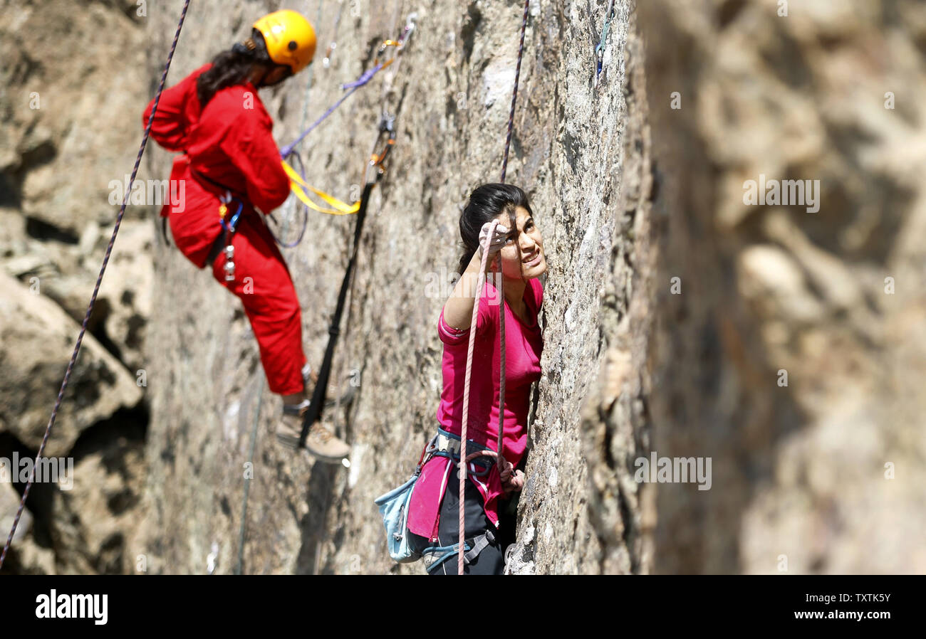 Iranian rock climber Mahsa Hossein Abadi (R) make her way up Pars Rock ...