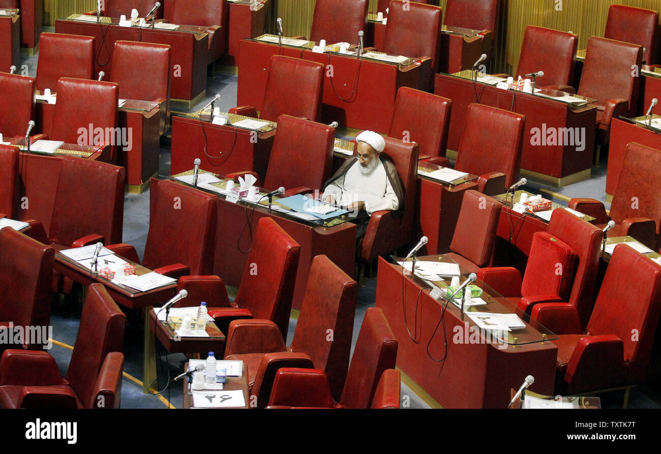 One of the members of Assembly of Experts sits in meeting room before ...