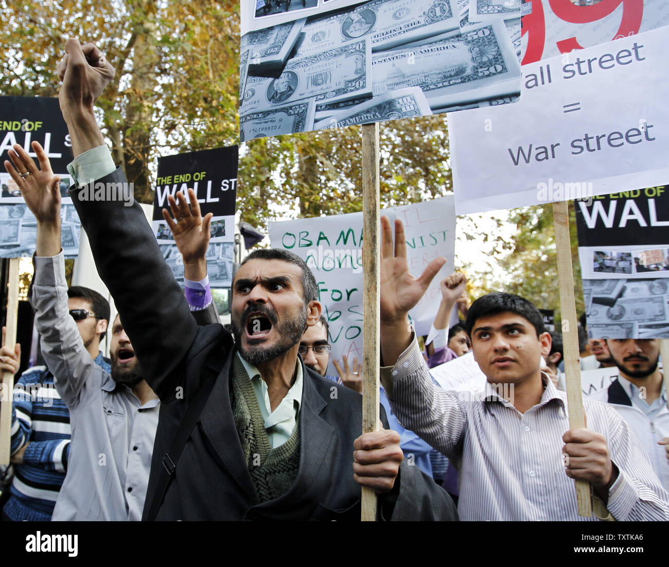 Iranian men gather in front of the Swiss Embassy in Tehran to show ...