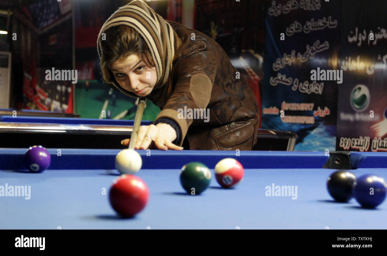 Iranian Nasrin Ahmadi, plays billiards in a sports center in Isfahan ...