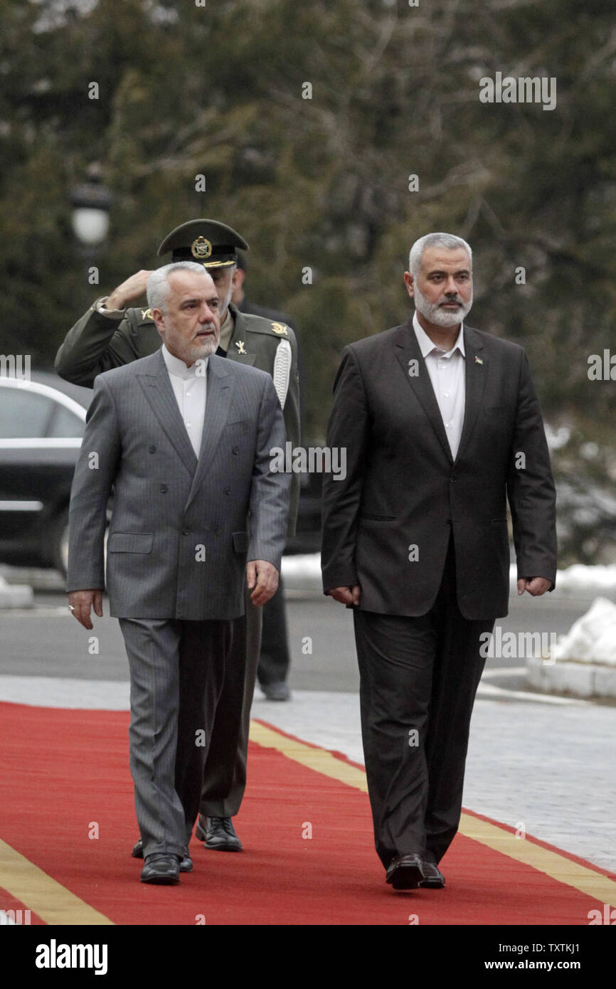 Iran's First vice president Mohammad Reza Rahimi (L) walks with the ...