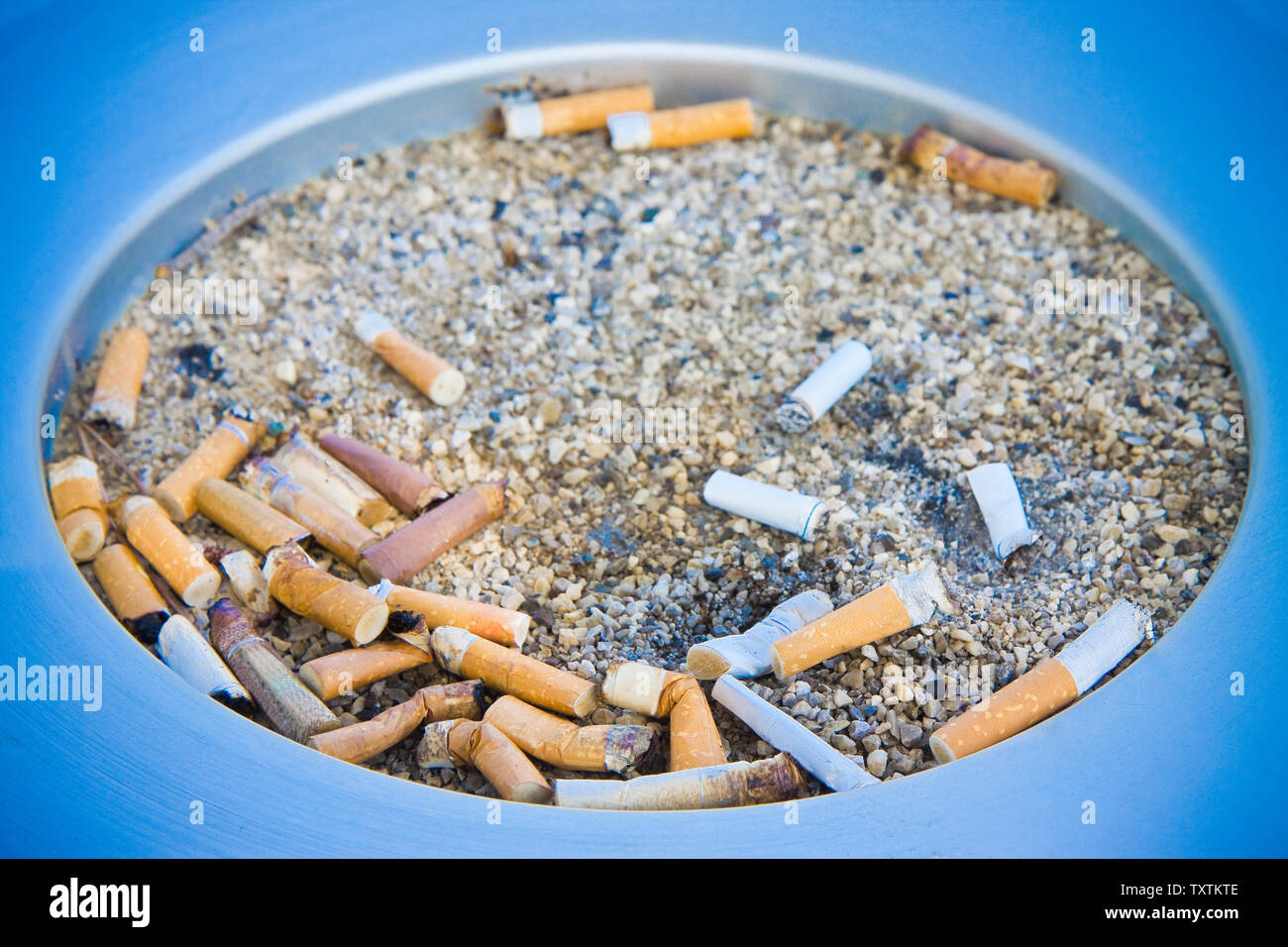 Cigarette butts brought together in a cigarette case wit sand Stock ...