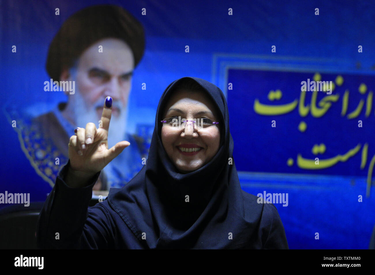 A hopeful for presidential election, Mihan Javid, shows her inked ...