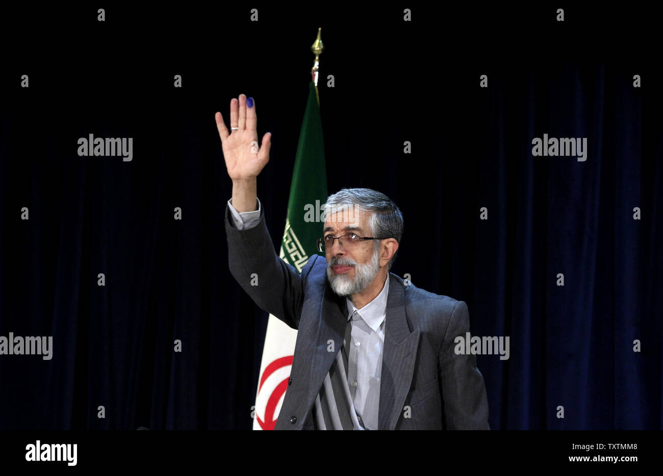 Lawmaker and former parliament speaker Gholam-Ali Haddad-Adel waves to ...