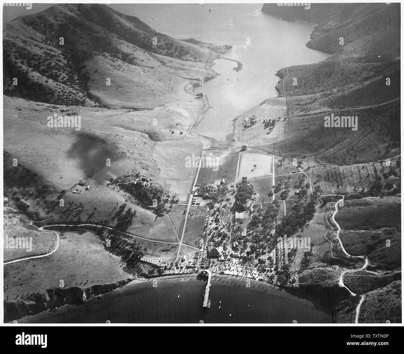 [Aerial view of Naval/Coast Guard base prominent in foreground and ...