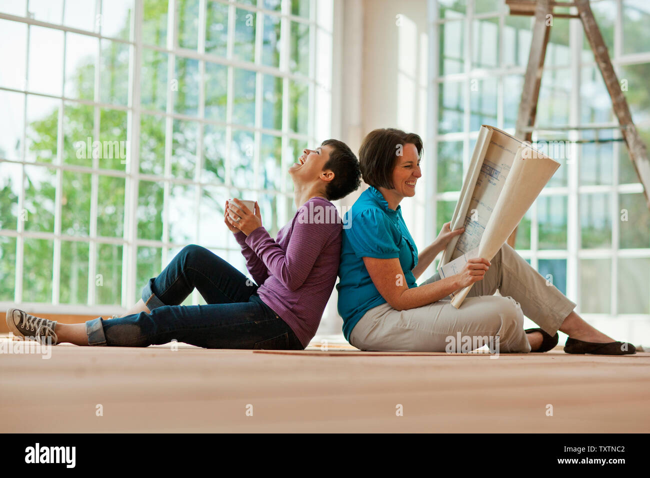 Mid adult couple bonding in their new home Stock Photo - Alamy