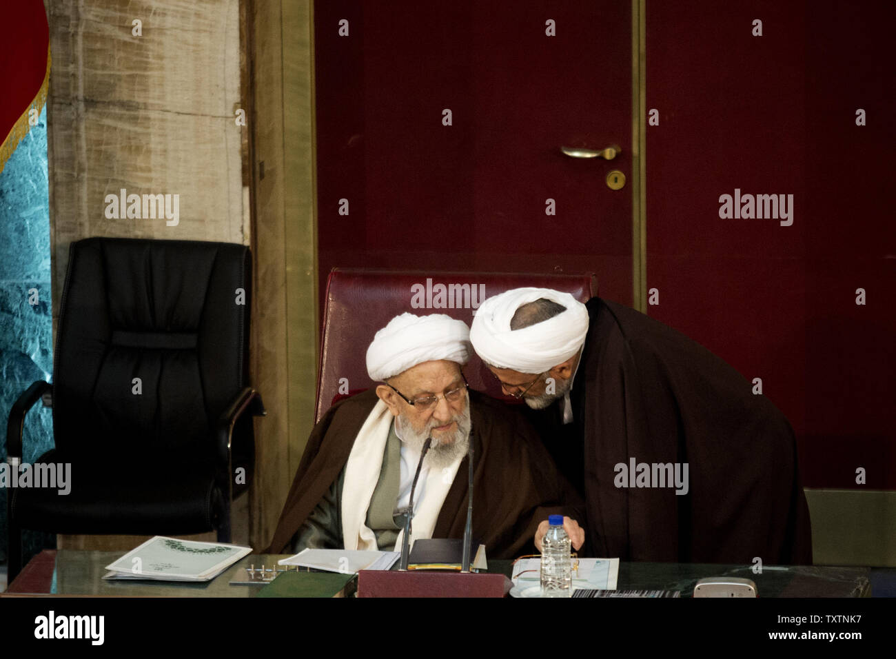 Chairman Mohammad Reza Mahdavi Kani (L) speaks with unidentified clergy ...