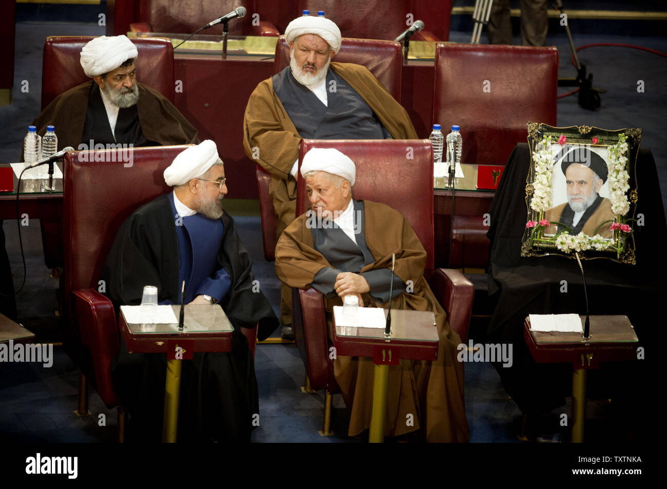 Iranian President Hassan Rowhani (L) speaks with former President ...