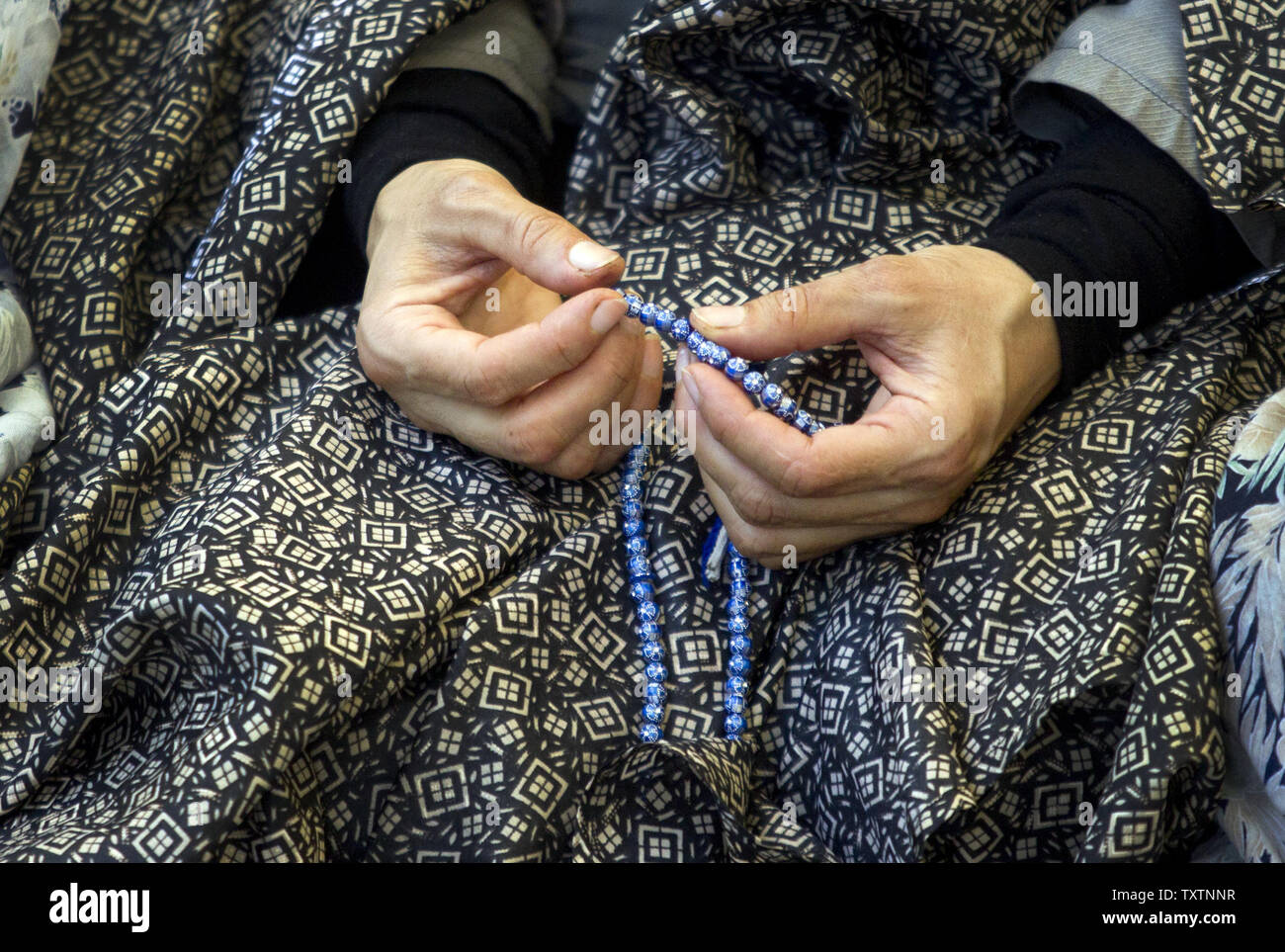 An Iranian woman uses prayer beads during weekly Friday prayers at ...