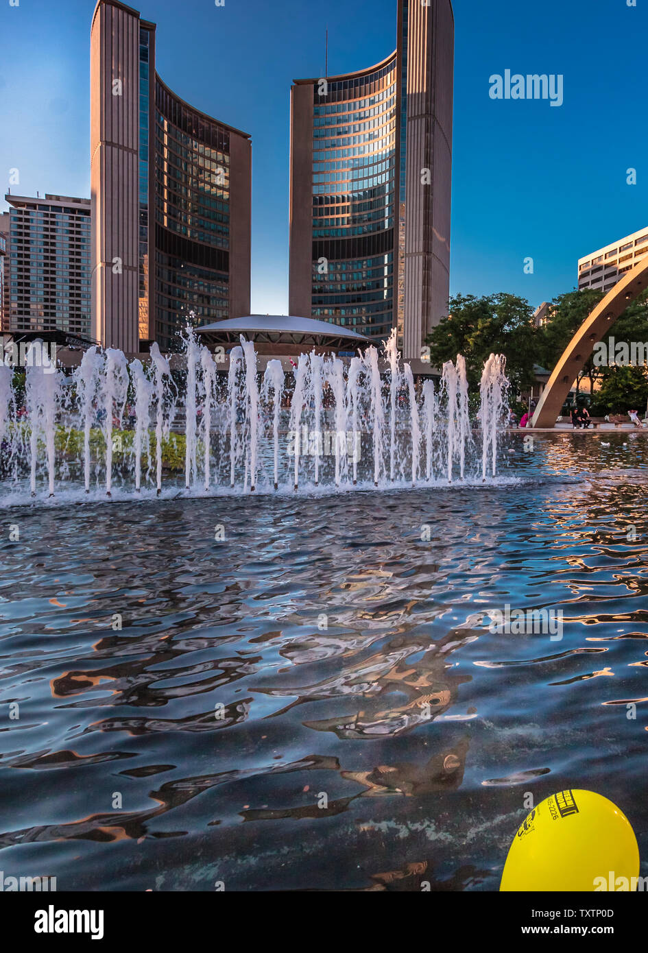 Vertical shot of City Hall of Toronto behind water fountains Stock ...