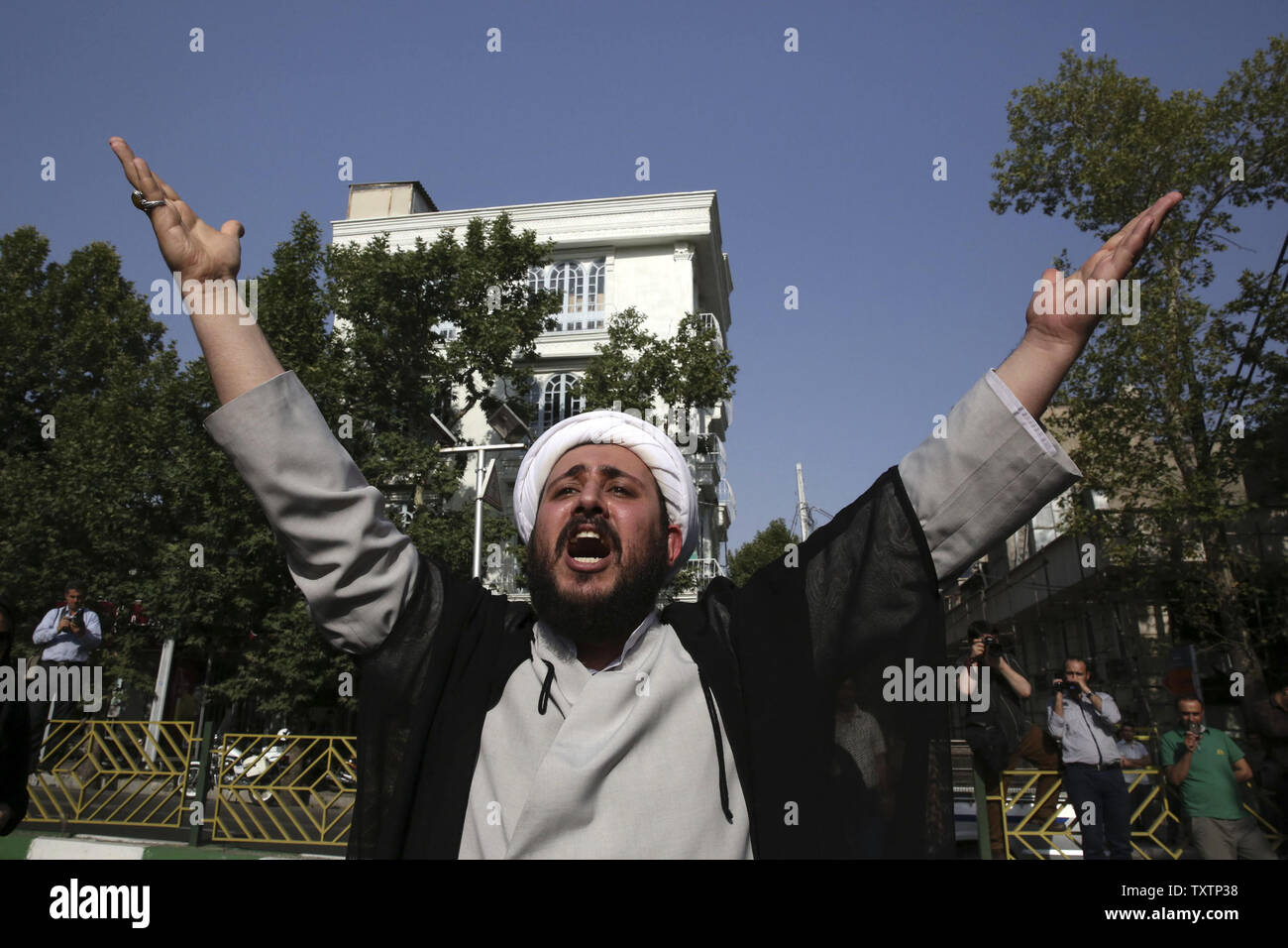 An Iranian hardliner shouts slogan as he attends demonstration to ...