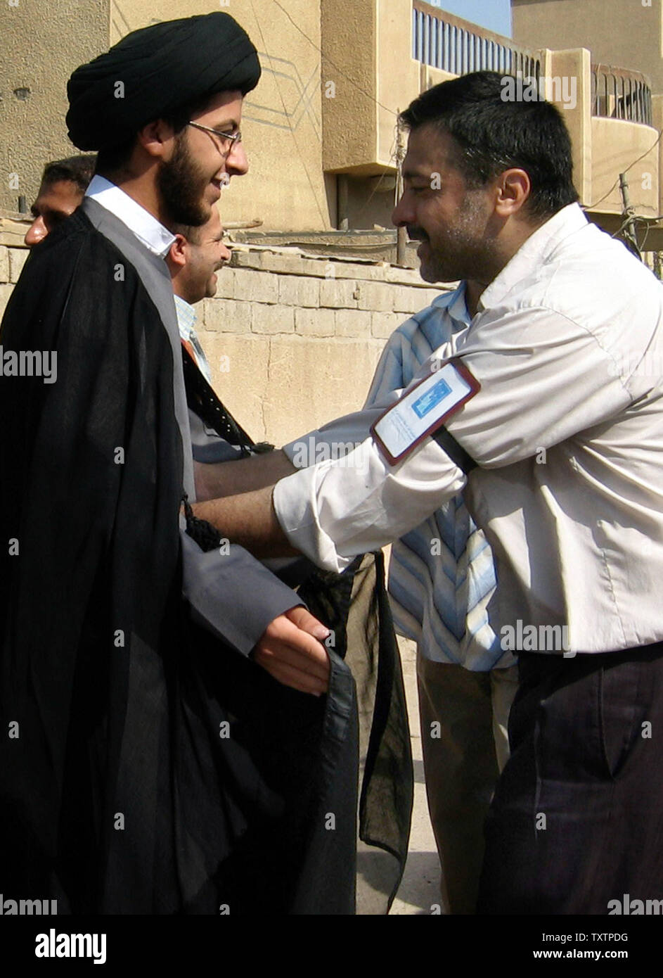 An Iraqi cleric man is checked before entering a voting station to vote ...