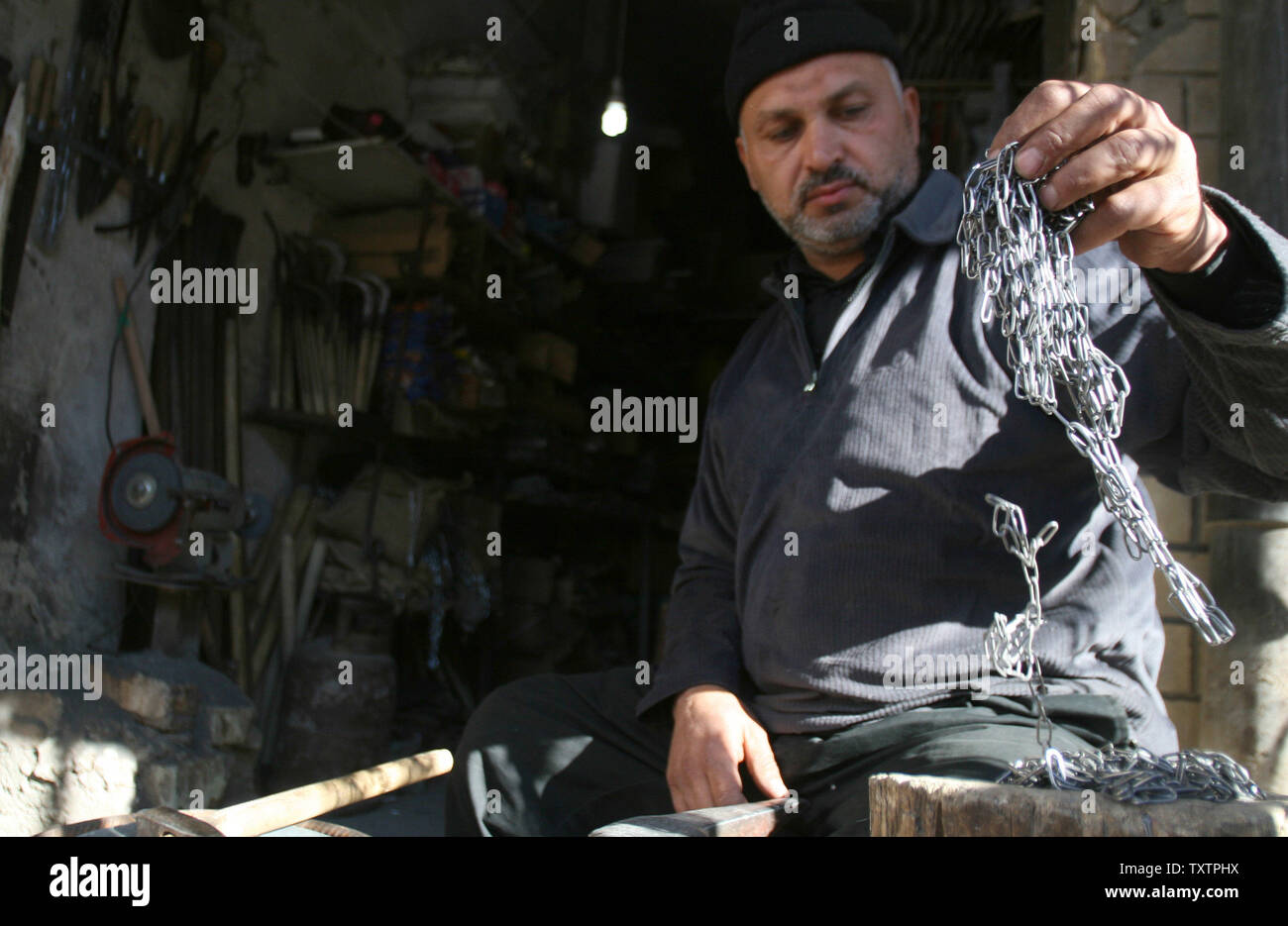 A Shiite blacksmith chain links used in making whips for part of Ashura ...