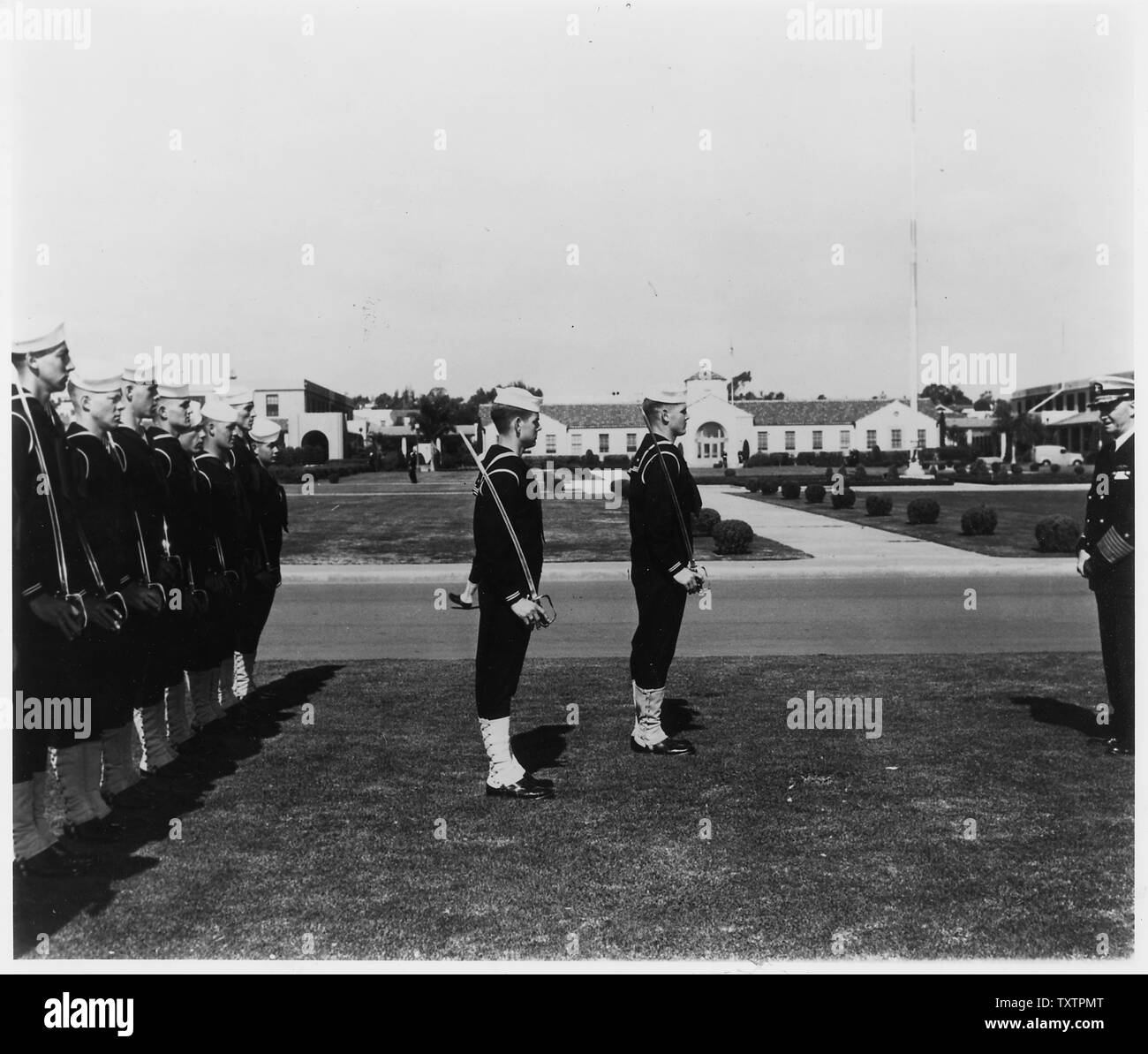 [Sailors presenting arms to their commanding officer on the parade ...