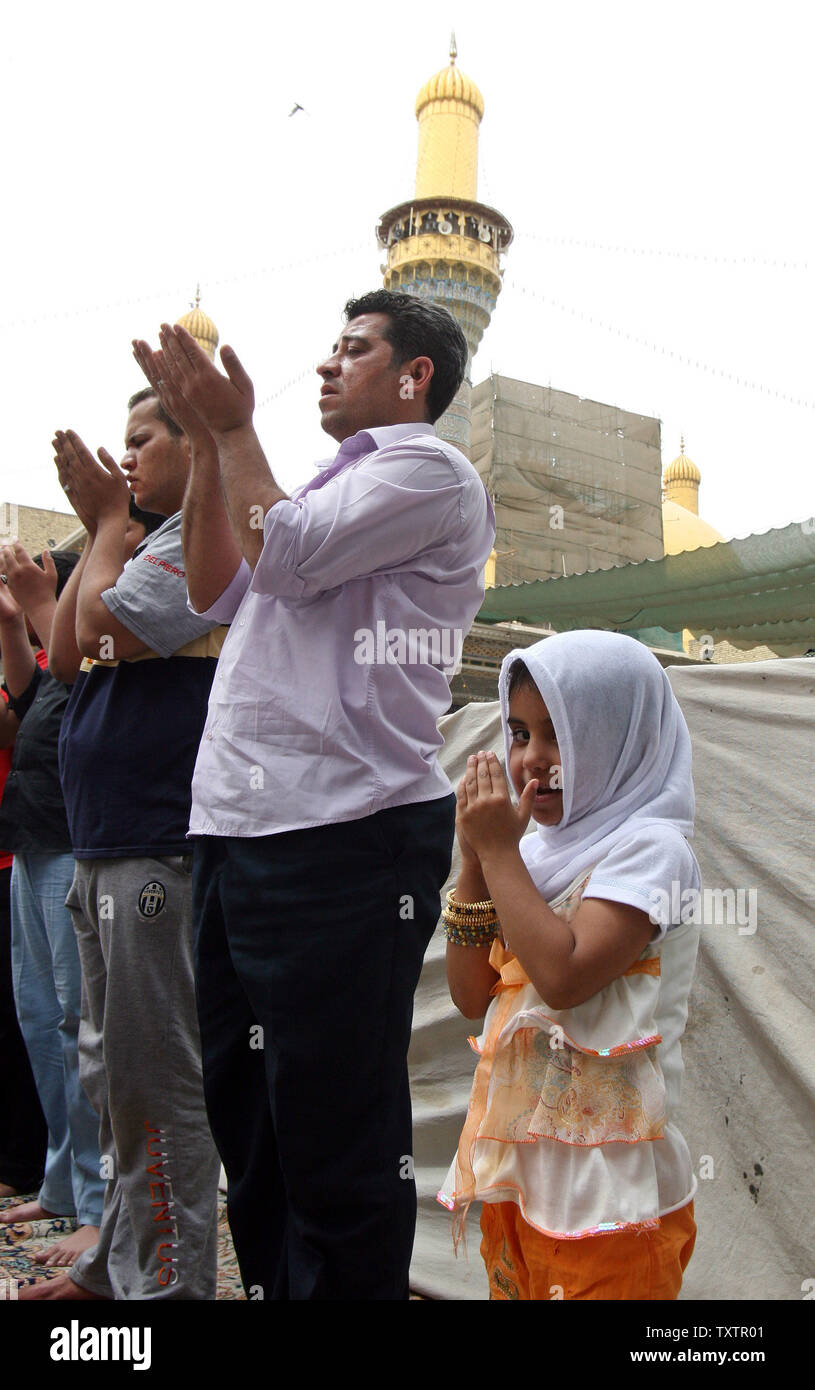 Iraqi pilgrims pray at the shrine of Imam Musa al-Kazim in Baghdad ...