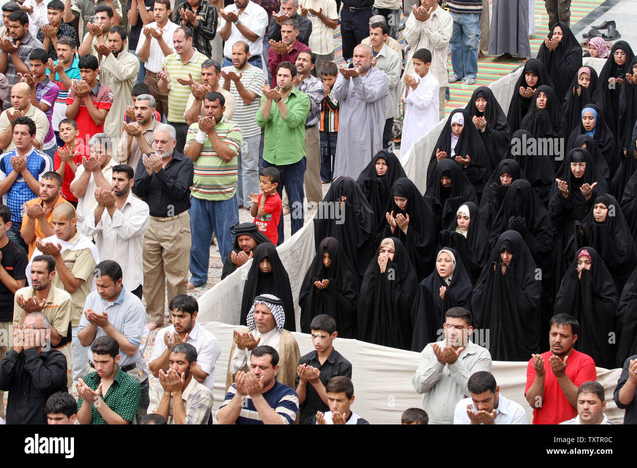 Iraqi pilgrims pray at the shrine of Imam Musa al-Kazim in Baghdad ...