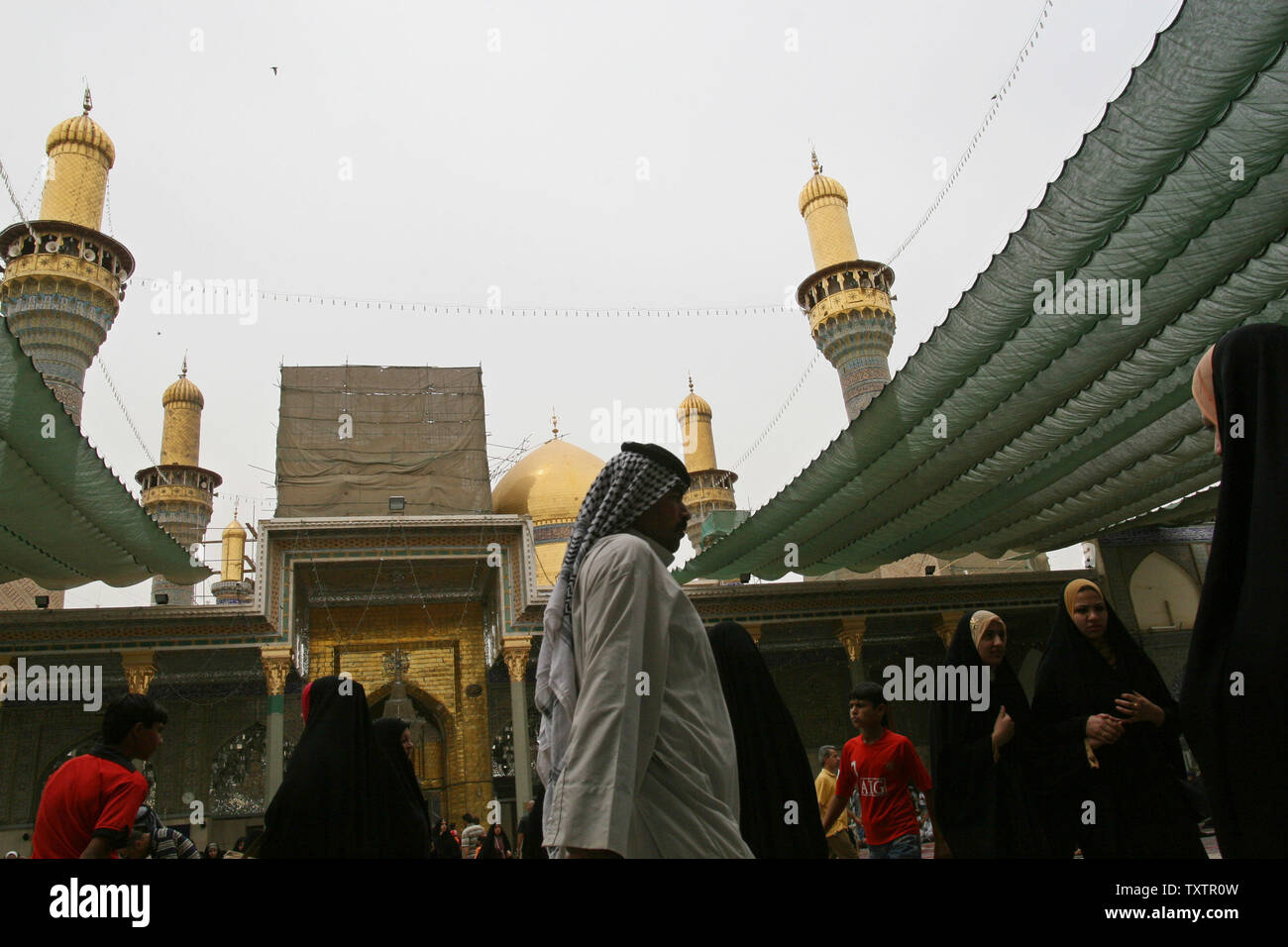 Iraqi pilgrims pray at the shrine of Imam Musa al-Kazim in Baghdad ...