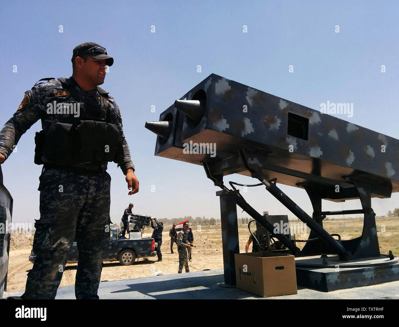 Iraqi counterterrorism forces load a Humvee with rockets to take to a ...