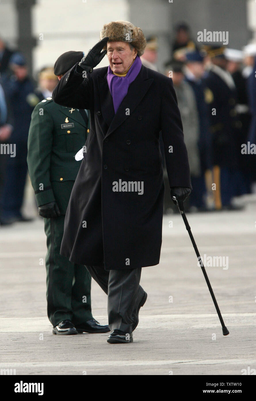 Former President George H. W. Bush gives a salute as he leaves the ...