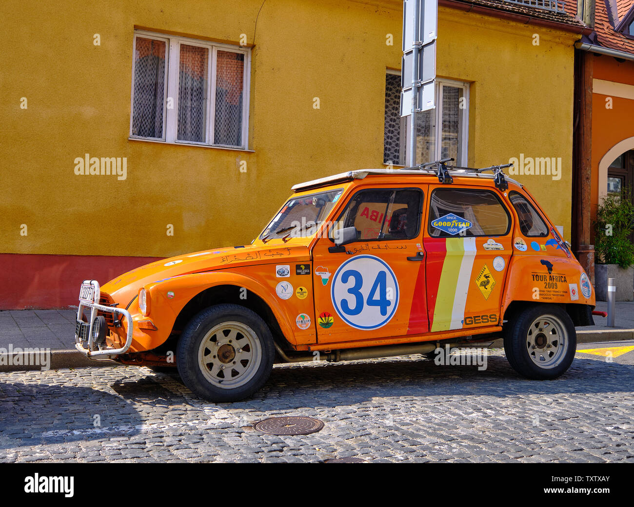 Orange Citroen 2CV (number 34) covered in expedition and meeting ...