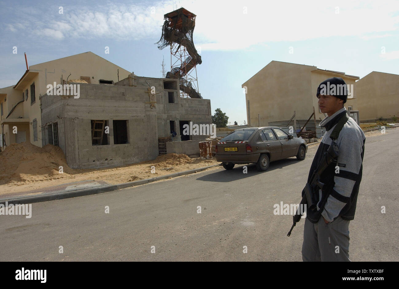 An Israeli army watchtower looms over Jewish settler, Itai Issak, 19 ...
