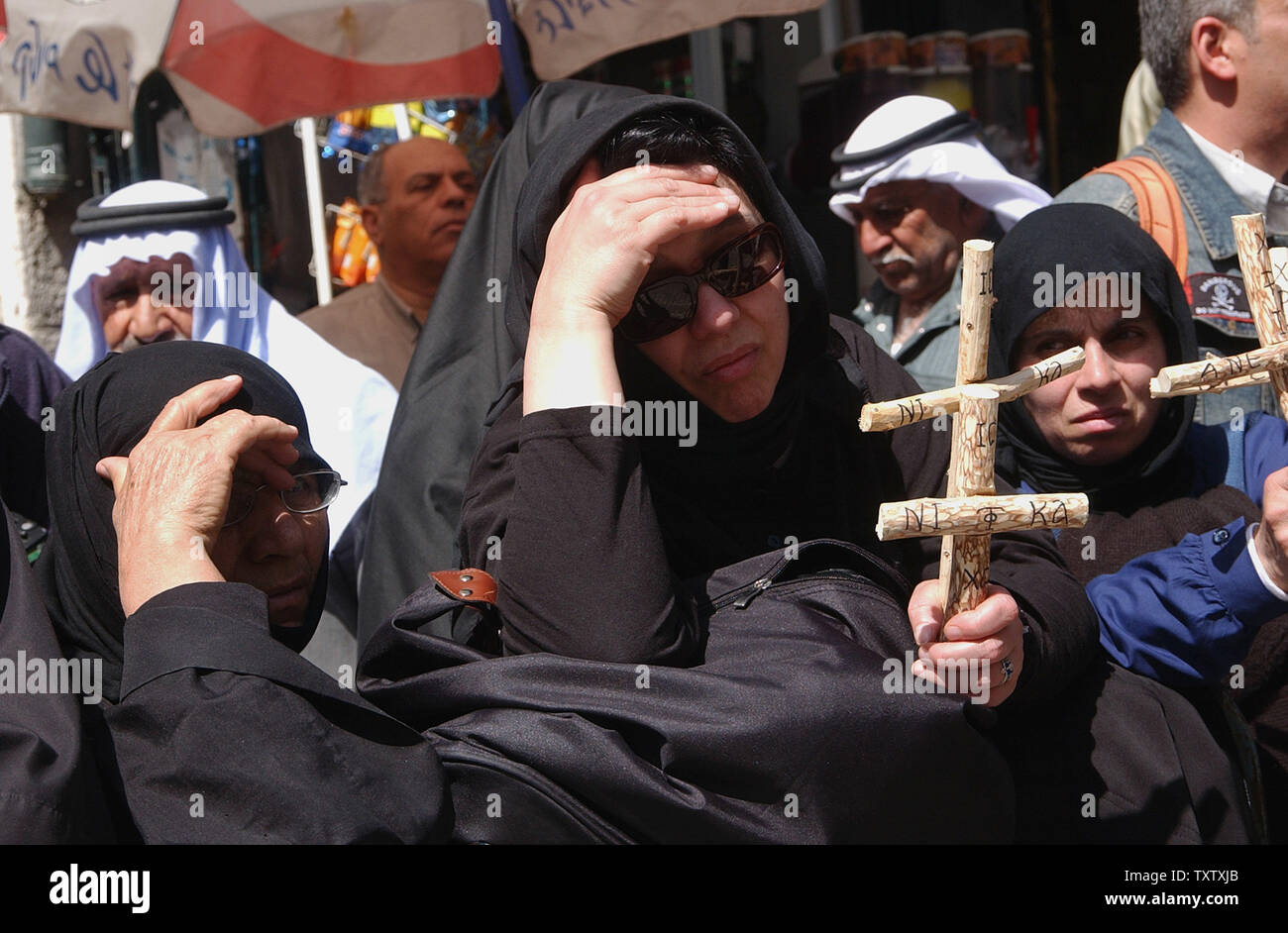 Palestinian muslims walk behind Greek Orthodox nuns holding crosses on ...