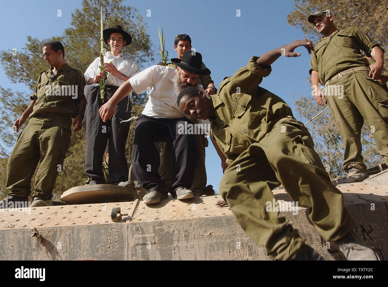 An Ultra-Orthodox Rabbi and Israeli soldier jump off of an armoured ...