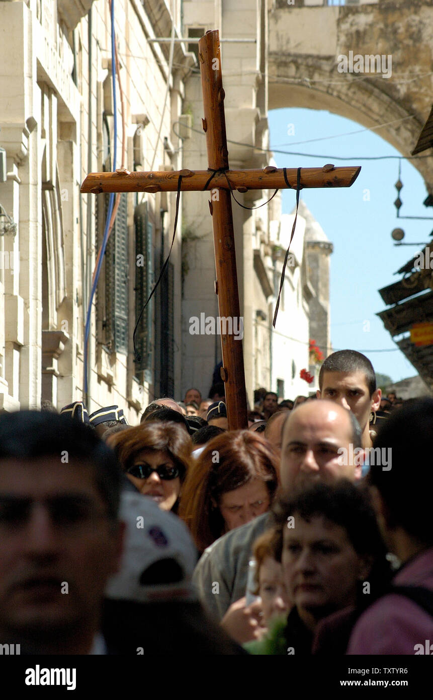 Christian pilgrims carry a cross on the Via Dolorosa, the traditional ...